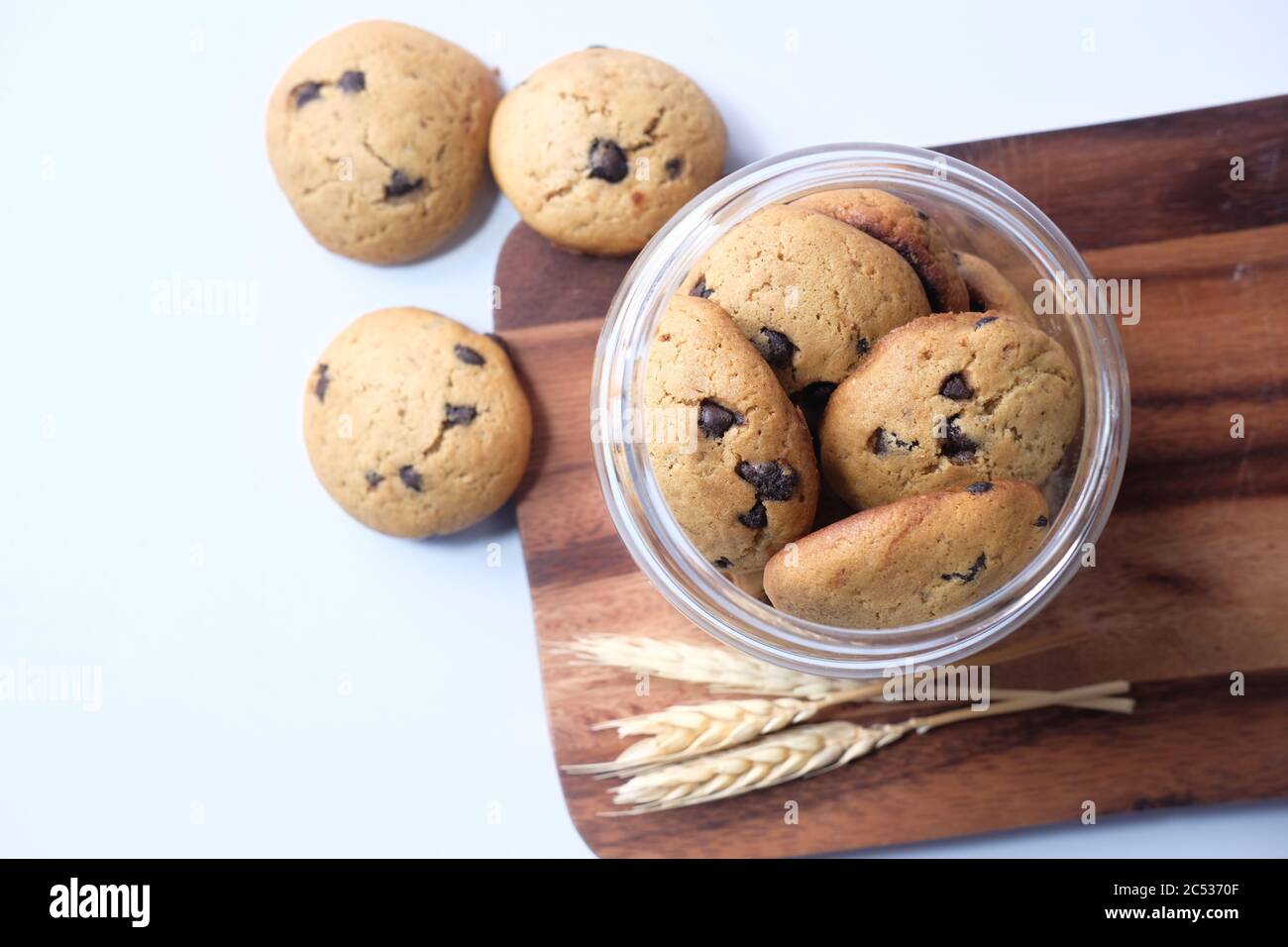 Jar full of chocolate chip cookies on white background Stock Photo - Alamy