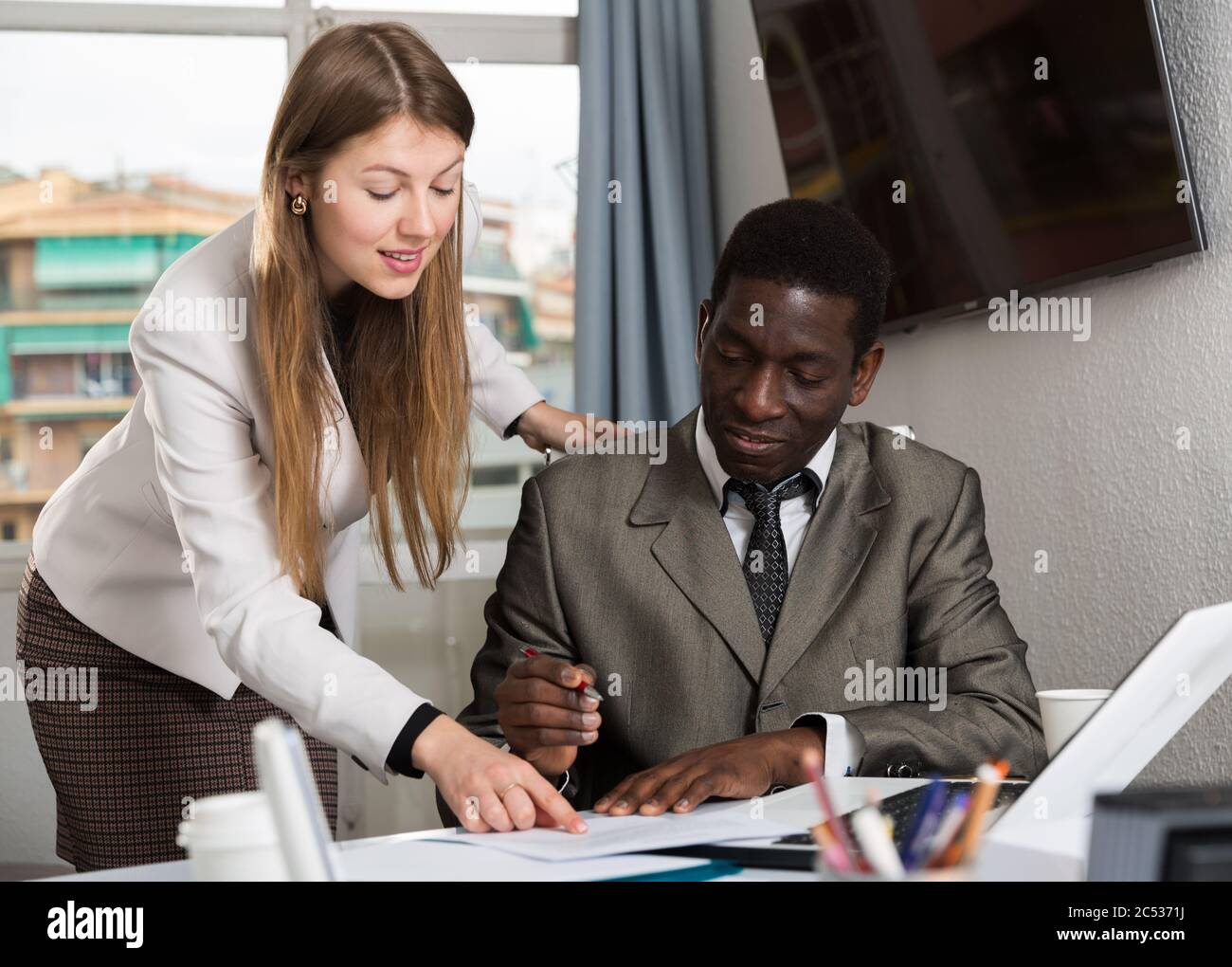 Friendly coworkers working together and flirting at workplace in modern ...