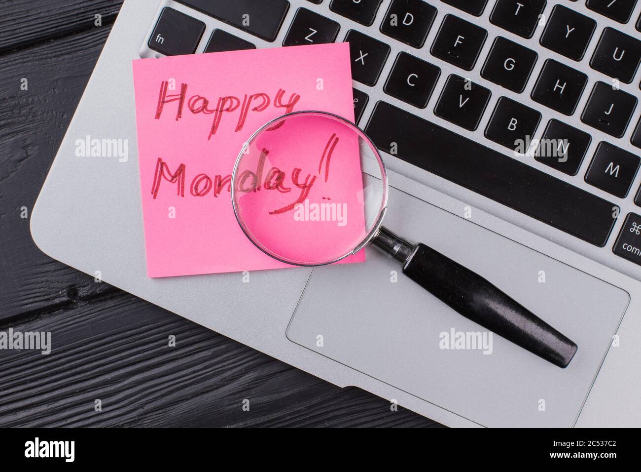 Close up laptop with glass magnifier and happy monday wish Stock Photo ...
