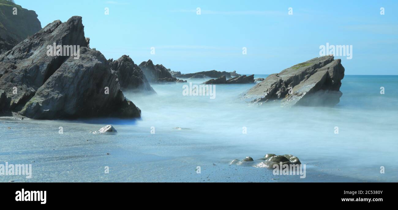 Rocks surrounded by blurred sea waves on th North Devon coast, England ...
