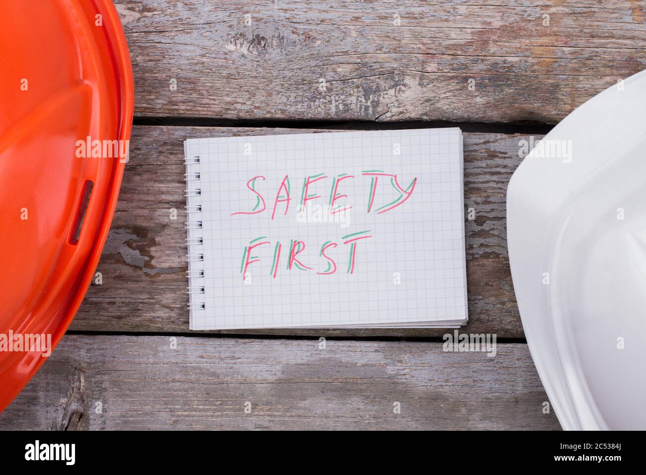 Safety first notice and construction helmets Stock Photo - Alamy