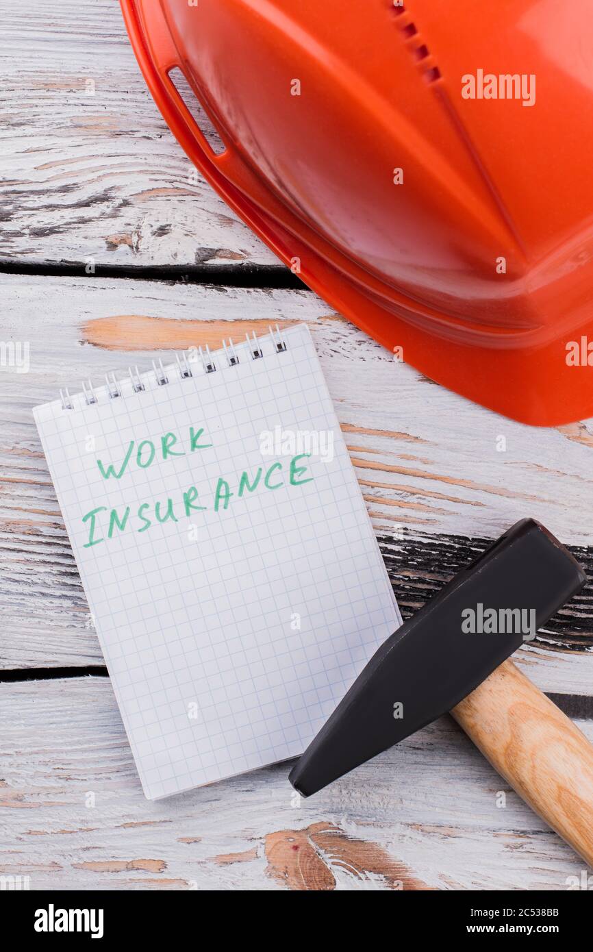 Work insurance note and worker's tools Stock Photo - Alamy