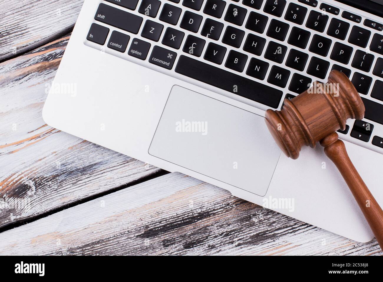 Wooden court gavel on a laptop keyboard Stock Photo - Alamy