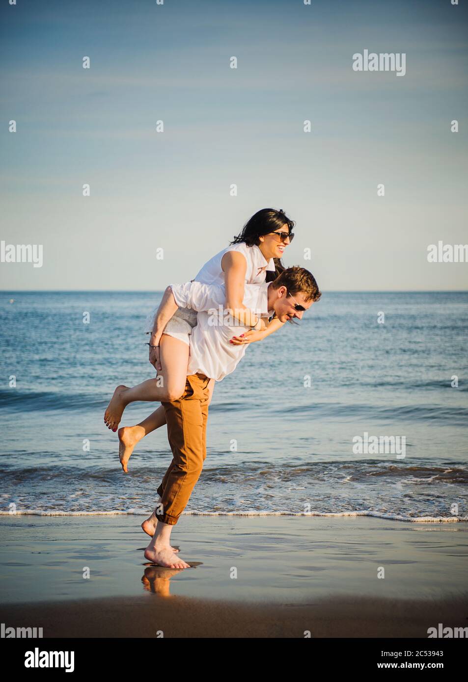 young couple having fun on the beach Stock Photo - Alamy