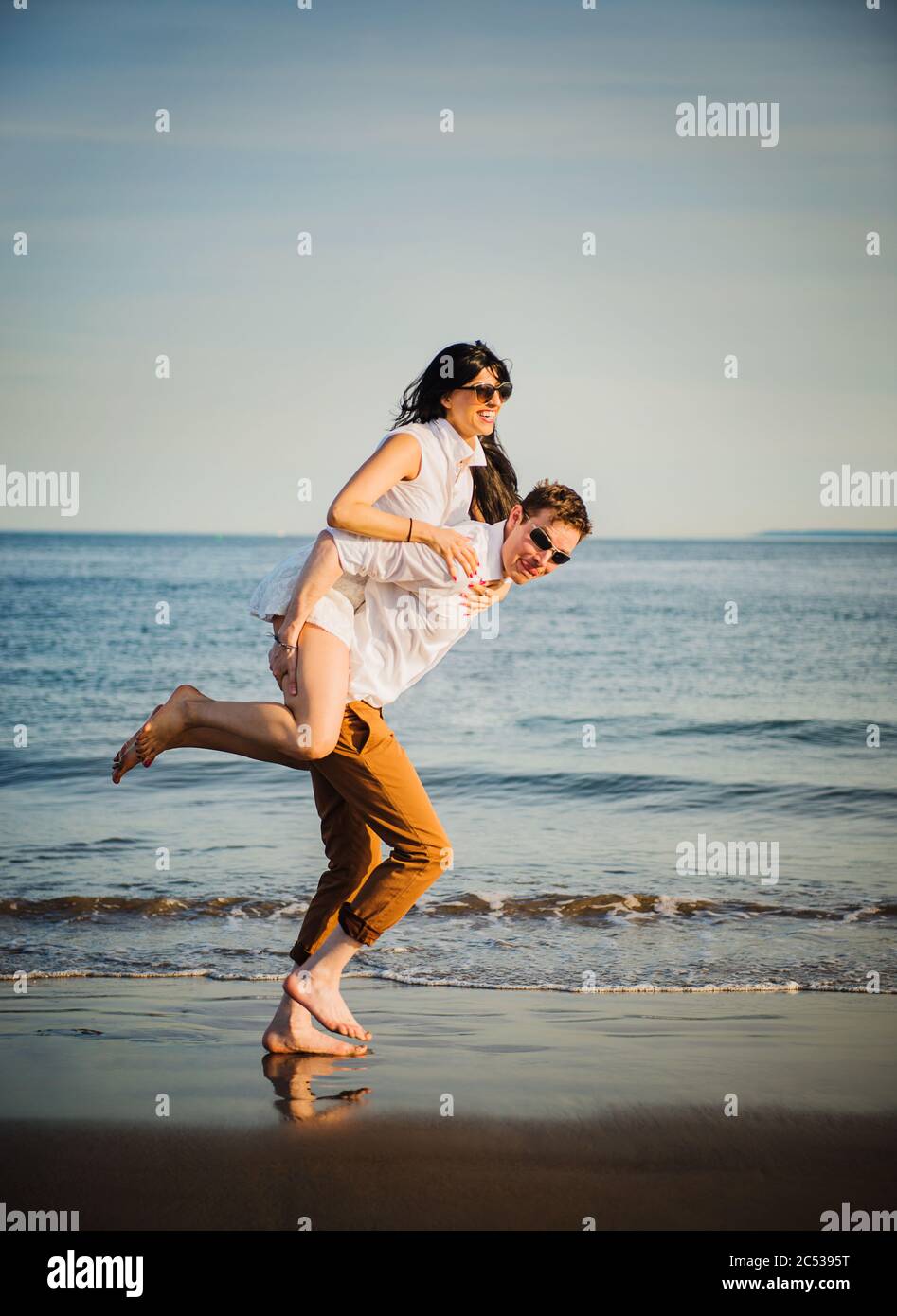 young couple having fun on the beach Stock Photo - Alamy