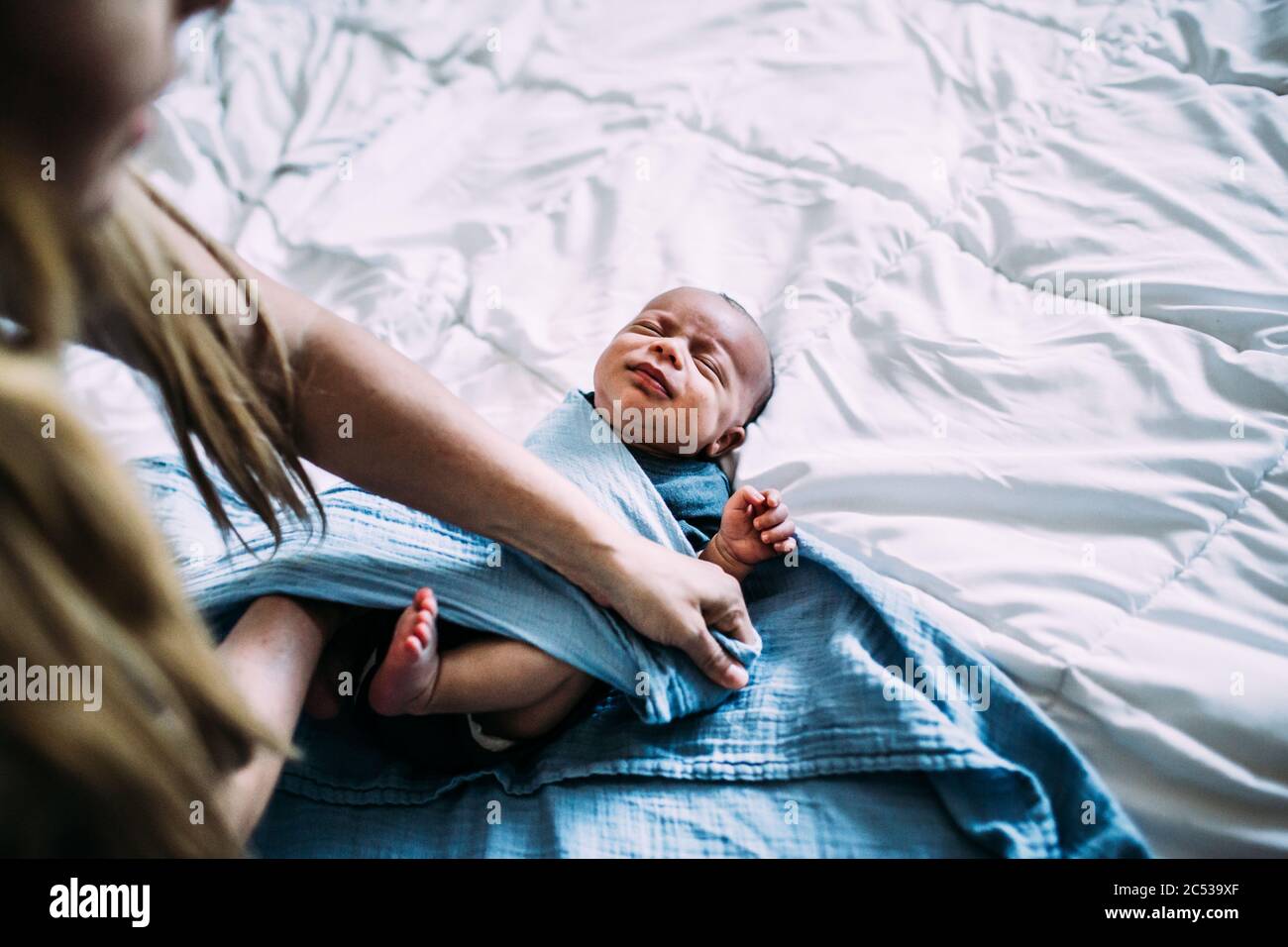 overhead shot of newborn baby being wrapped in blanket Stock Photo - Alamy
