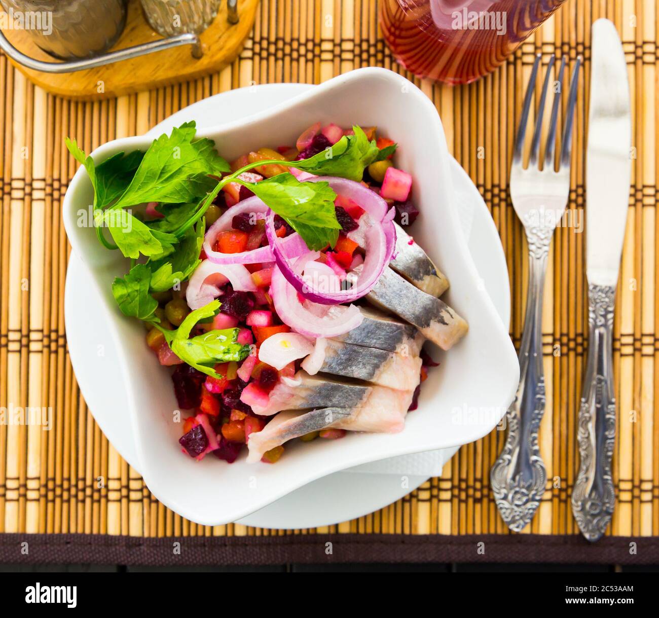Popular russian salad Vinegret with chopped roots, vegetables, herring ...
