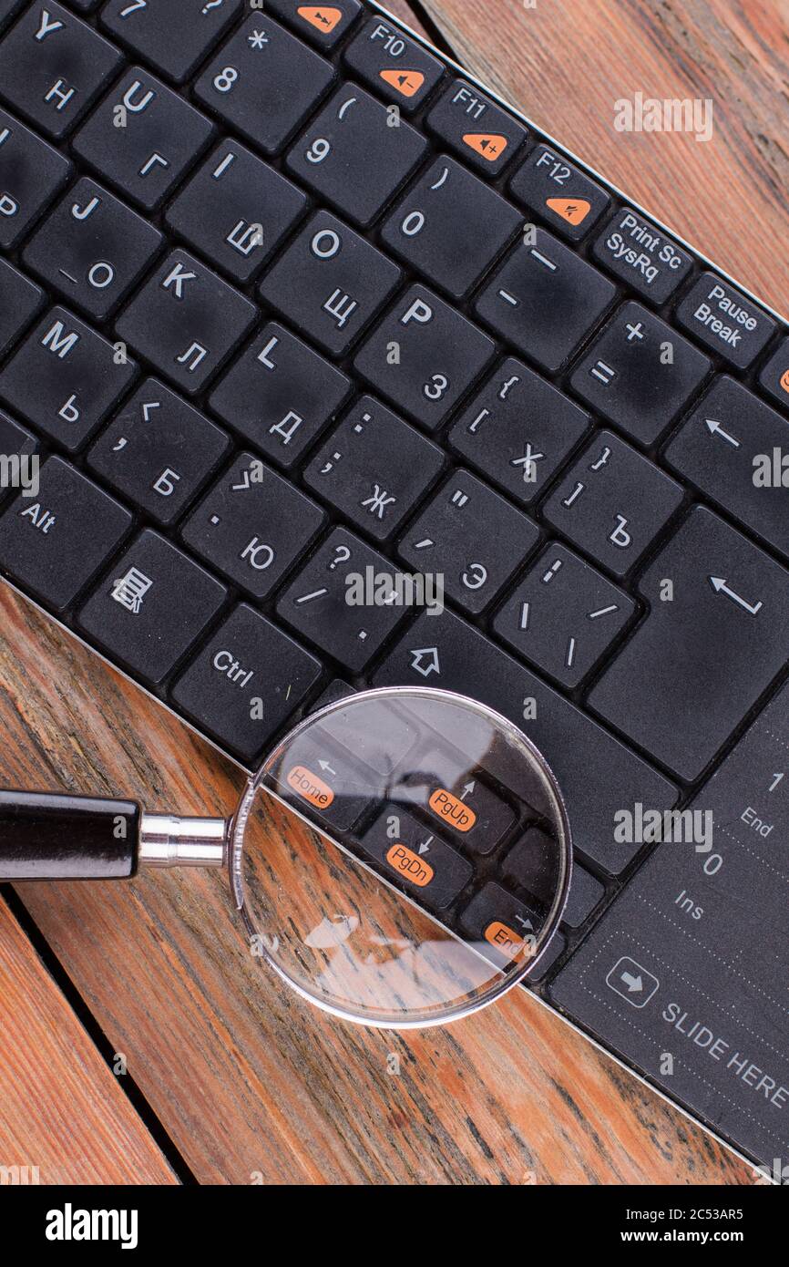 Magnifying glass over arrows key in the keyboard Stock Photo - Alamy