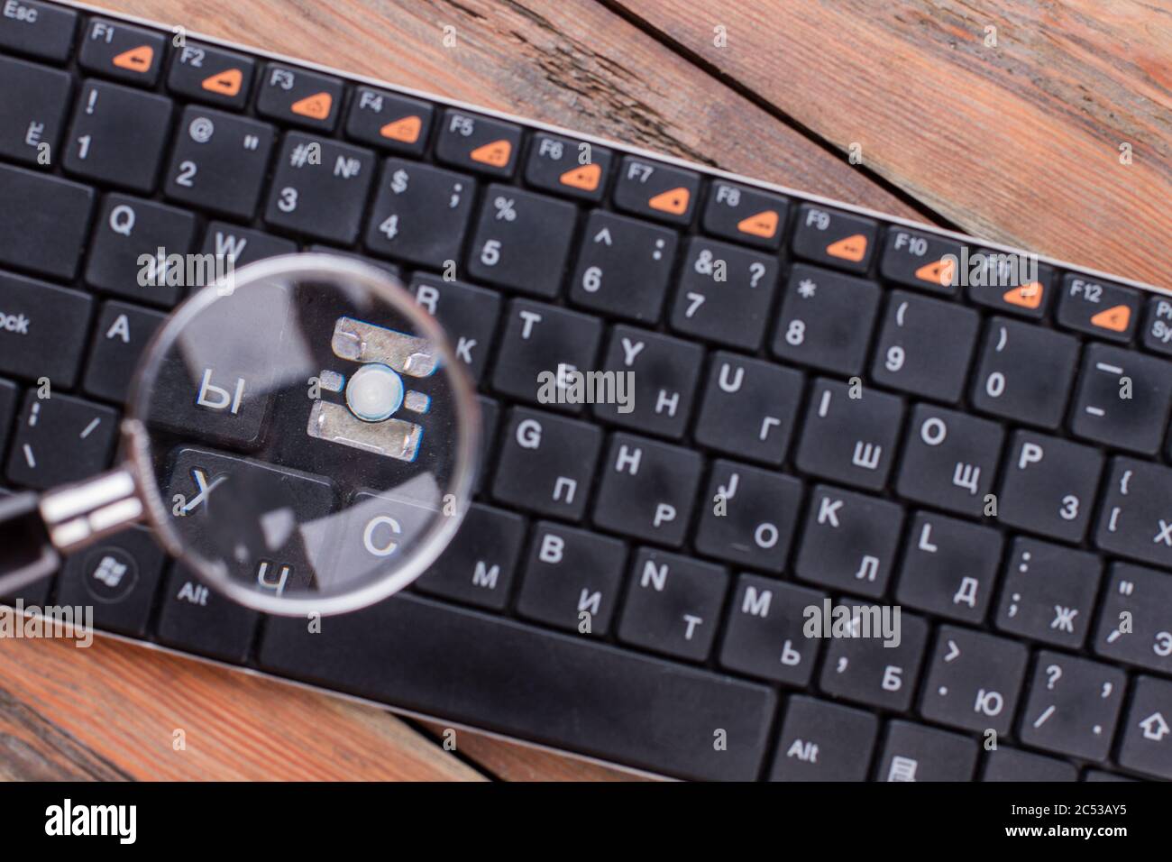 Magnifying glass over missing key in the keyboard Stock Photo - Alamy