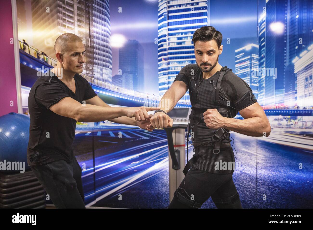 young man training with his personal trainer indoors Stock Photo - Alamy