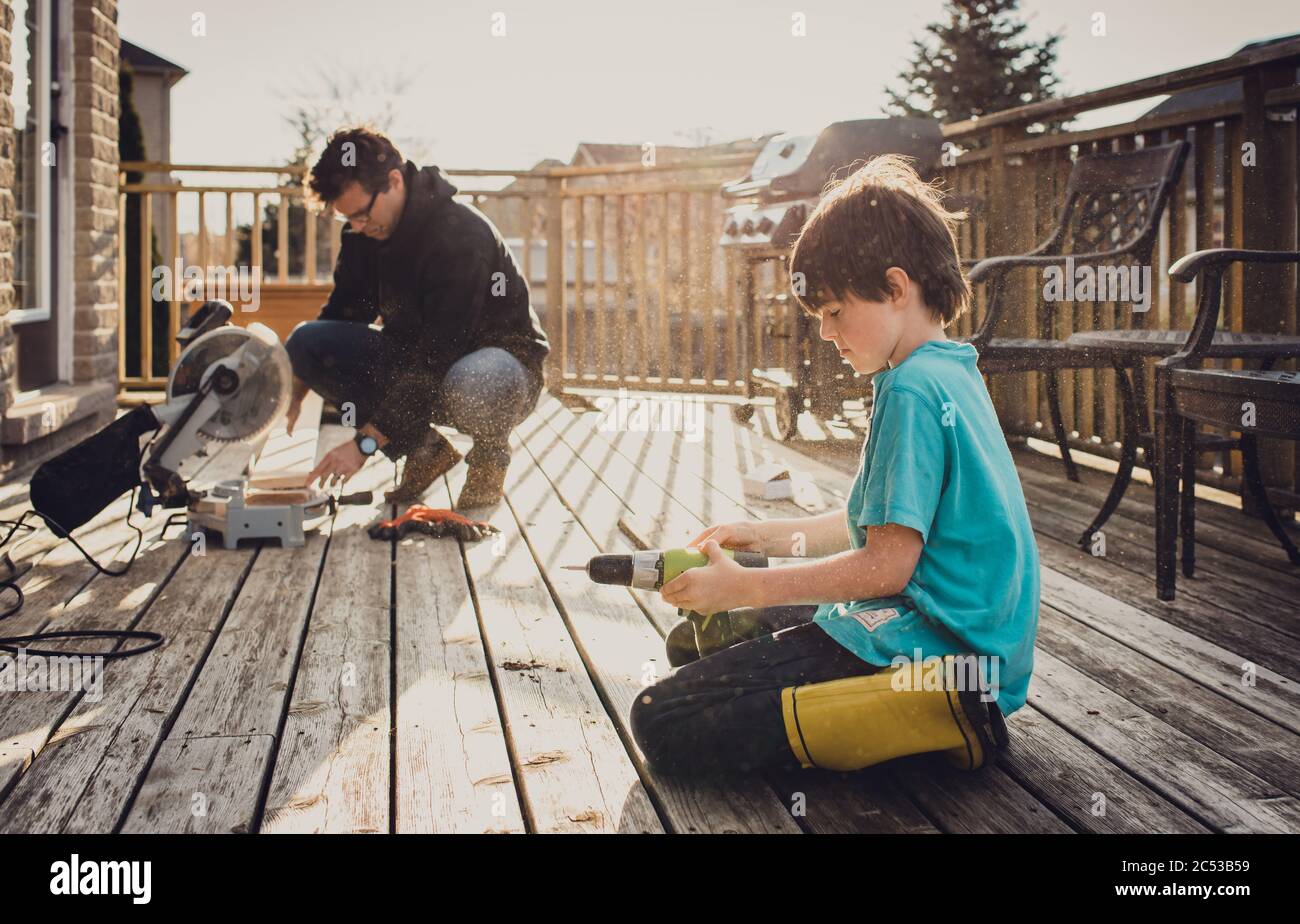 Father son cutting wood hi-res stock photography and images - Alamy