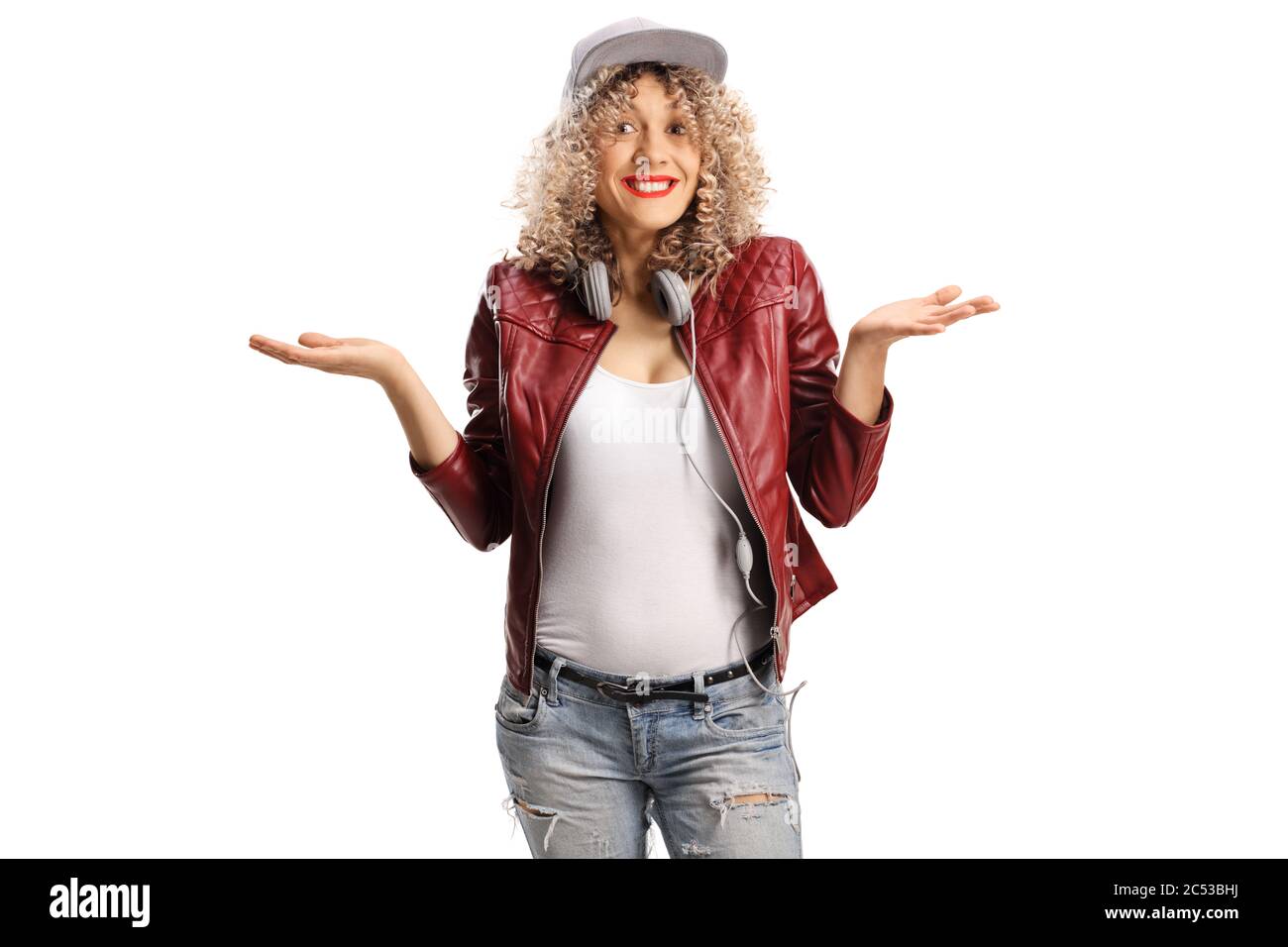 Careless young woman with a curly blond hair gesturing with hands ...