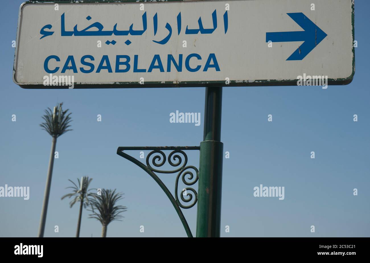 Road signs by medieval wall ramparts and the medina old town in ...