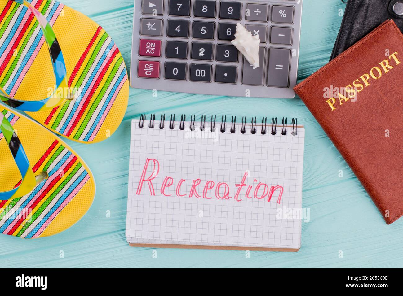 Flat lay passport, flip-flops, calculator on table meaning for plan to ...
