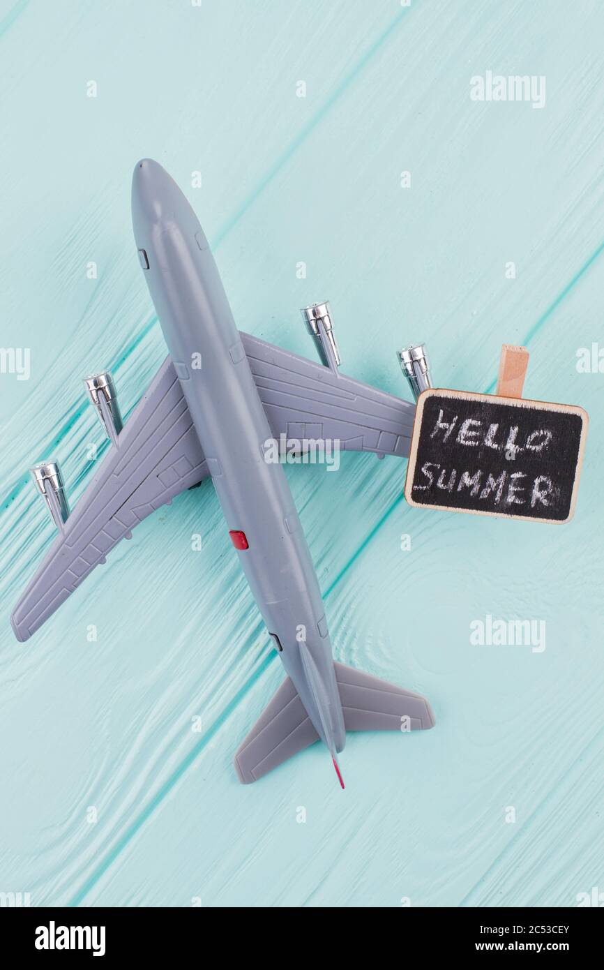 Flat lay grey toy plane with chalkboard on blue desk Stock Photo - Alamy