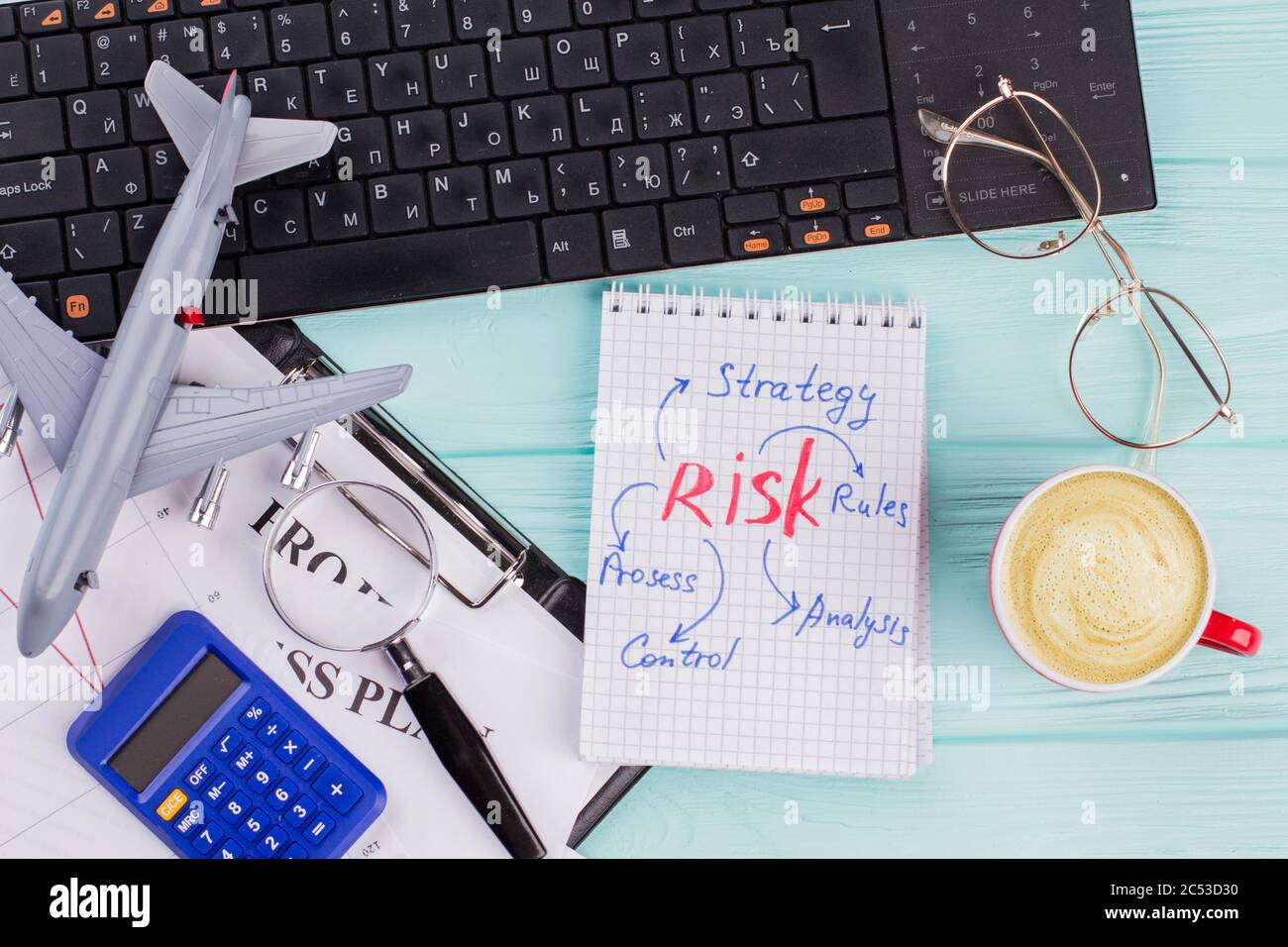 Office desk with stuff and note about risk Stock Photo - Alamy
