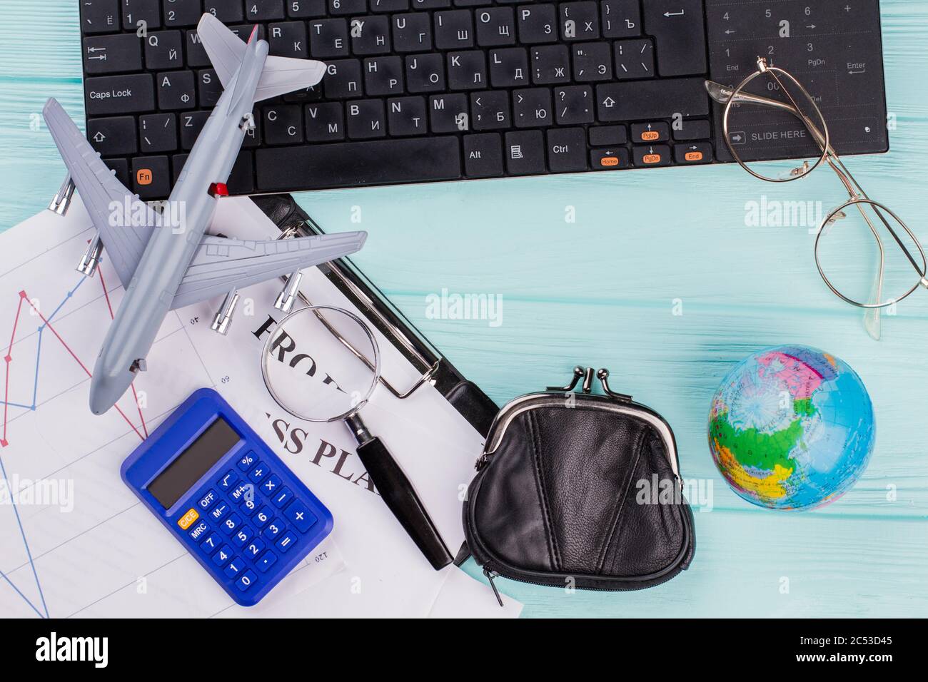 A lot of messy stuff on the blue table with keyboard Stock Photo - Alamy