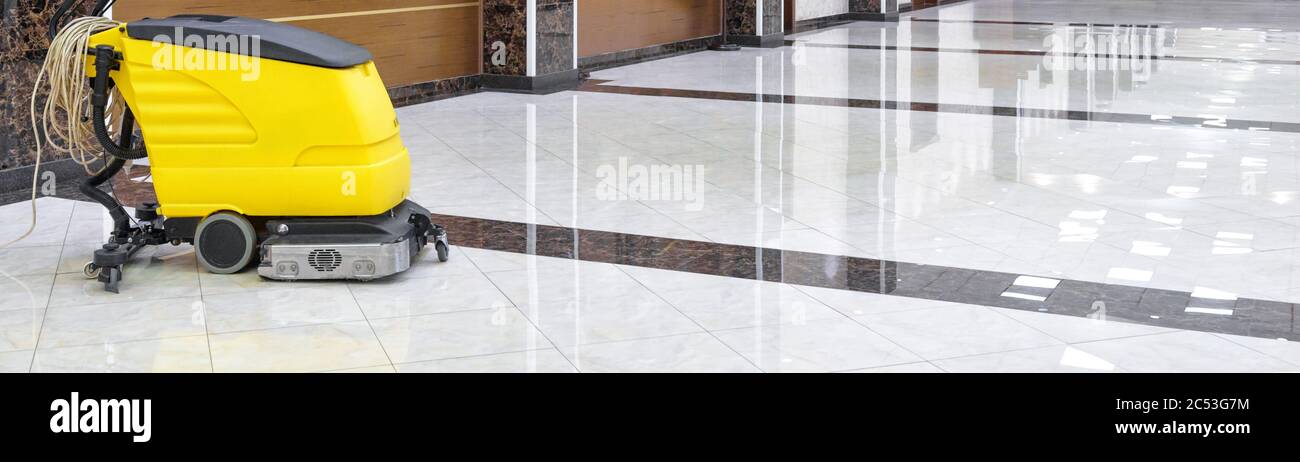 Cleaning machine in an office lobby. Cleaned floor in the interior of ...