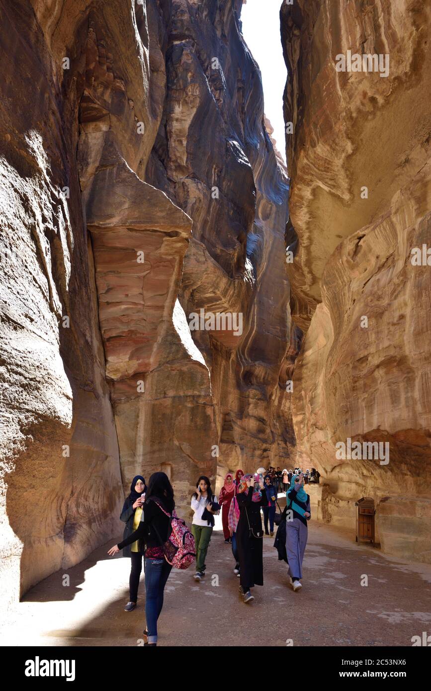 PETRA, JORDAN - APR 2, 2015: Tourists walking in Siq canyon in Petra ...