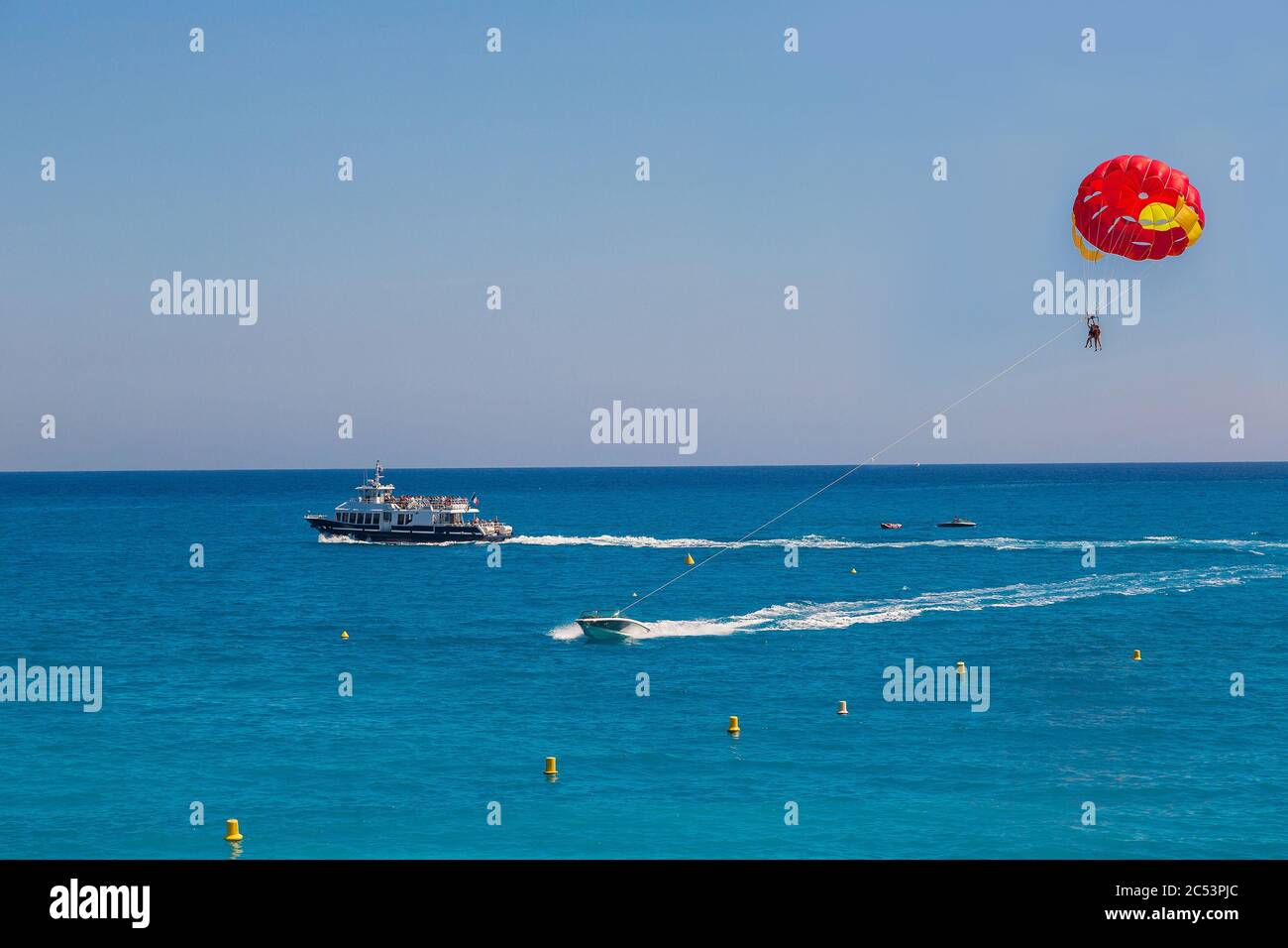Parachuting in Nice. Parasailing with a boat over sea in Nice in a ...