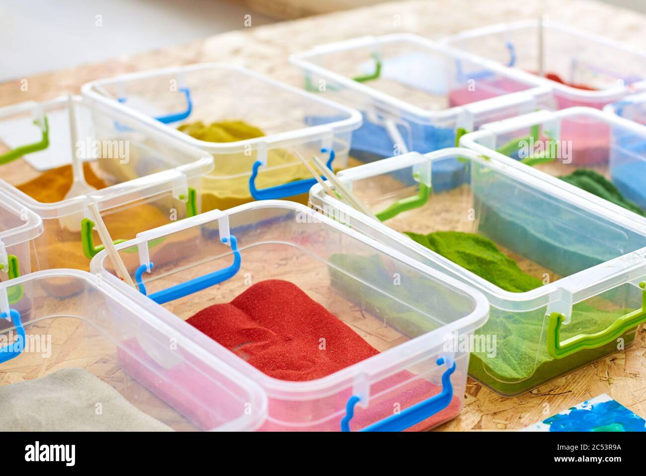 Multi-colored sand for drawing in plastic containers, close-up Stock ...