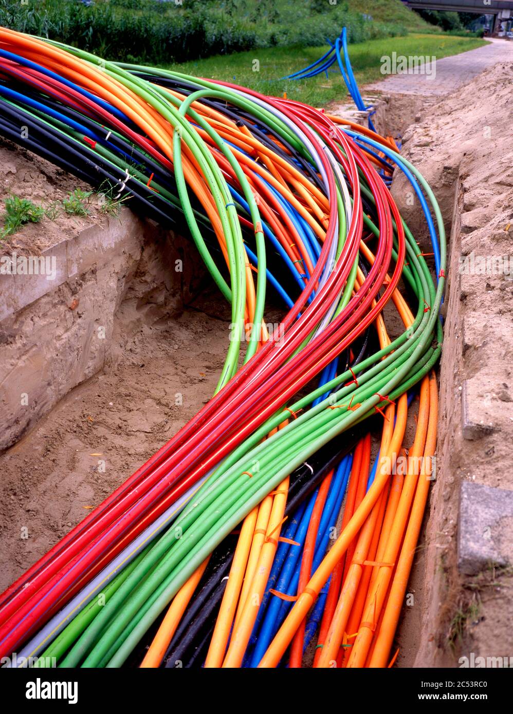Various multicolor optical fiber cables in the ground ready to be ...
