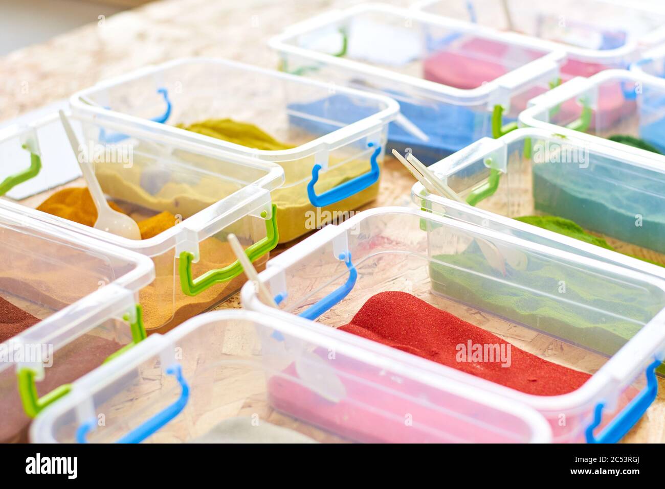 Multi-colored sand for drawing in plastic containers, close-up Stock ...
