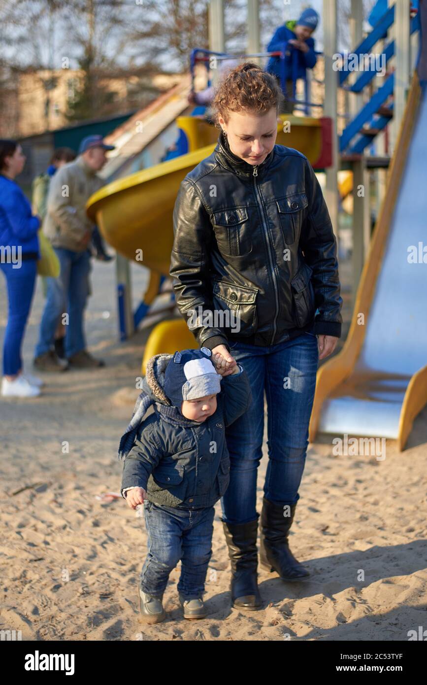 Mom leads her son off the playground because of bad behavior Stock ...
