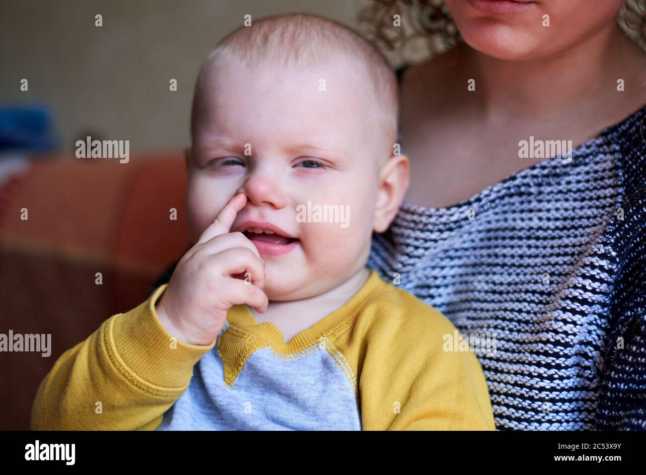 Little funny cute boy with finger in nose Stock Photo - Alamy