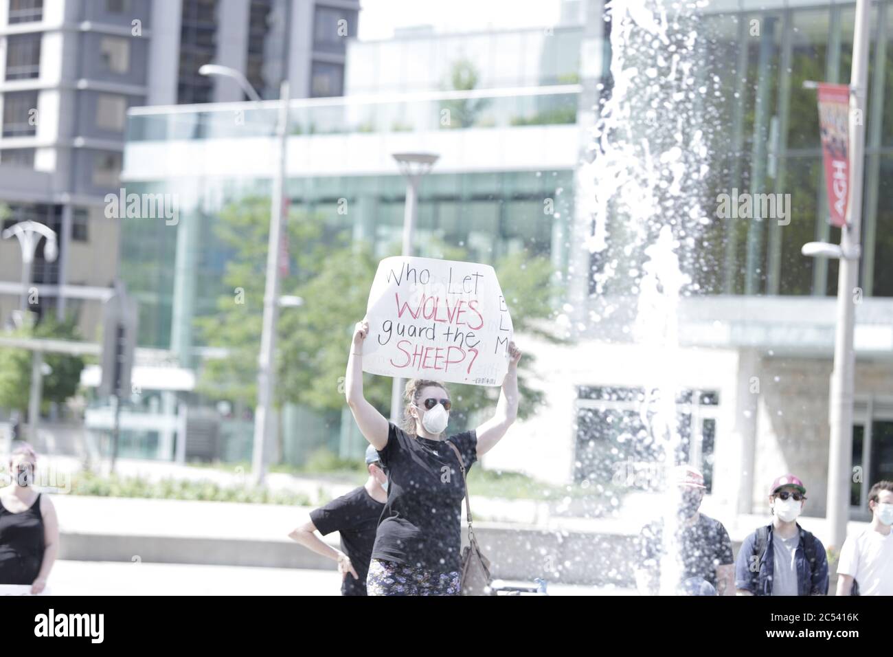 Canadian protesters gather at the Hamilton City Hall with posters to ...