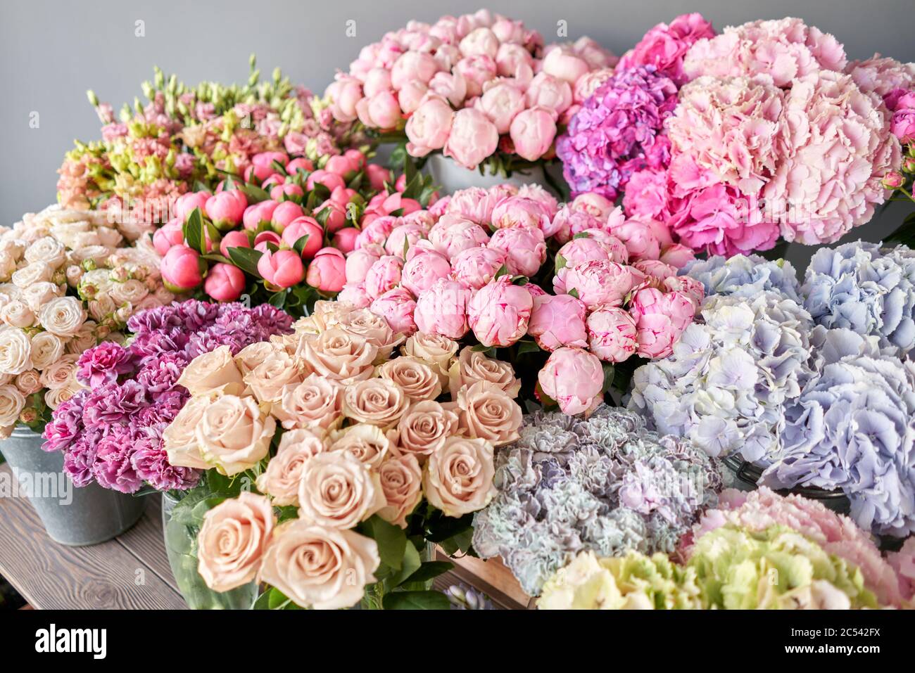 Many different colors on the stand or wooden table in the flower shop ...