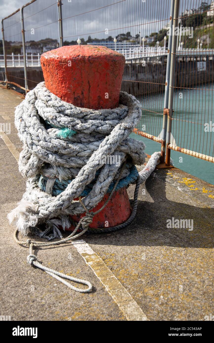 Thick rope wrapped around Red bollard at Torquay Harbour Stock Photo ...
