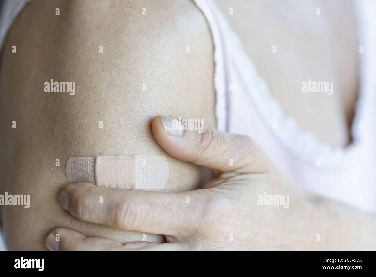 Bandage on a woman's arm next to her hand Stock Photo - Alamy