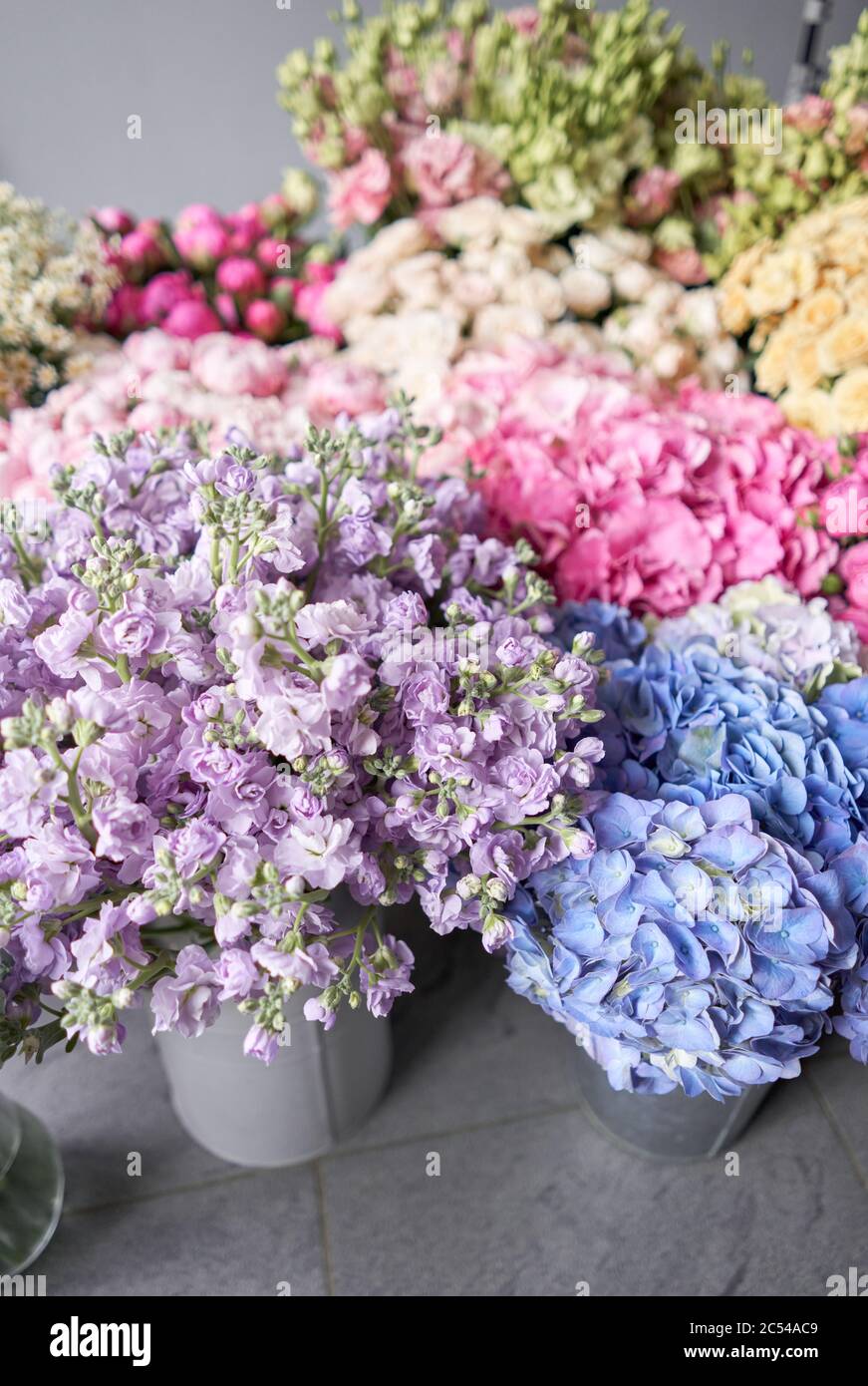 Many different colors on the stand or wooden table in the flower shop ...
