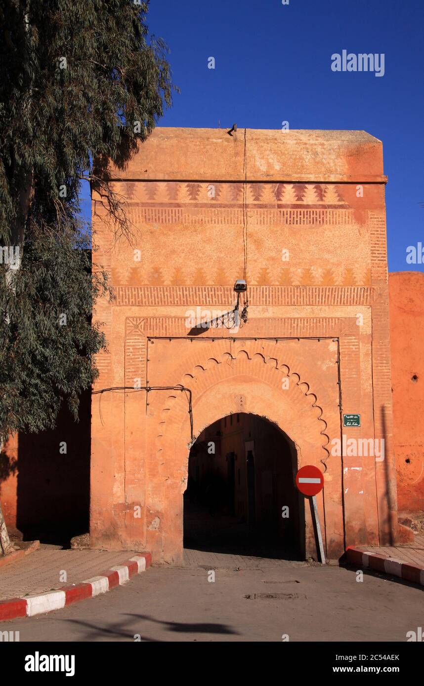 Morocco, Marrakesh. Medieval city wall and arched city gate leading to ...