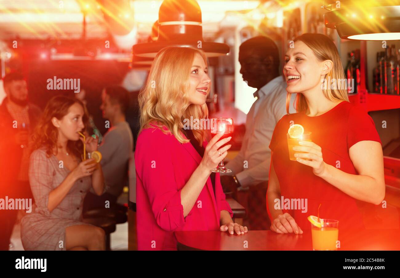 Happy positive females friends with cocktail in the club on party Stock ...