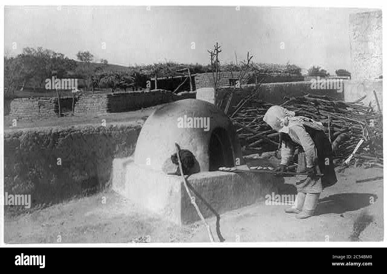 Indian woman baking in outdoor oven. ‘Par-dah-weh‘; Southwestern U.S ...