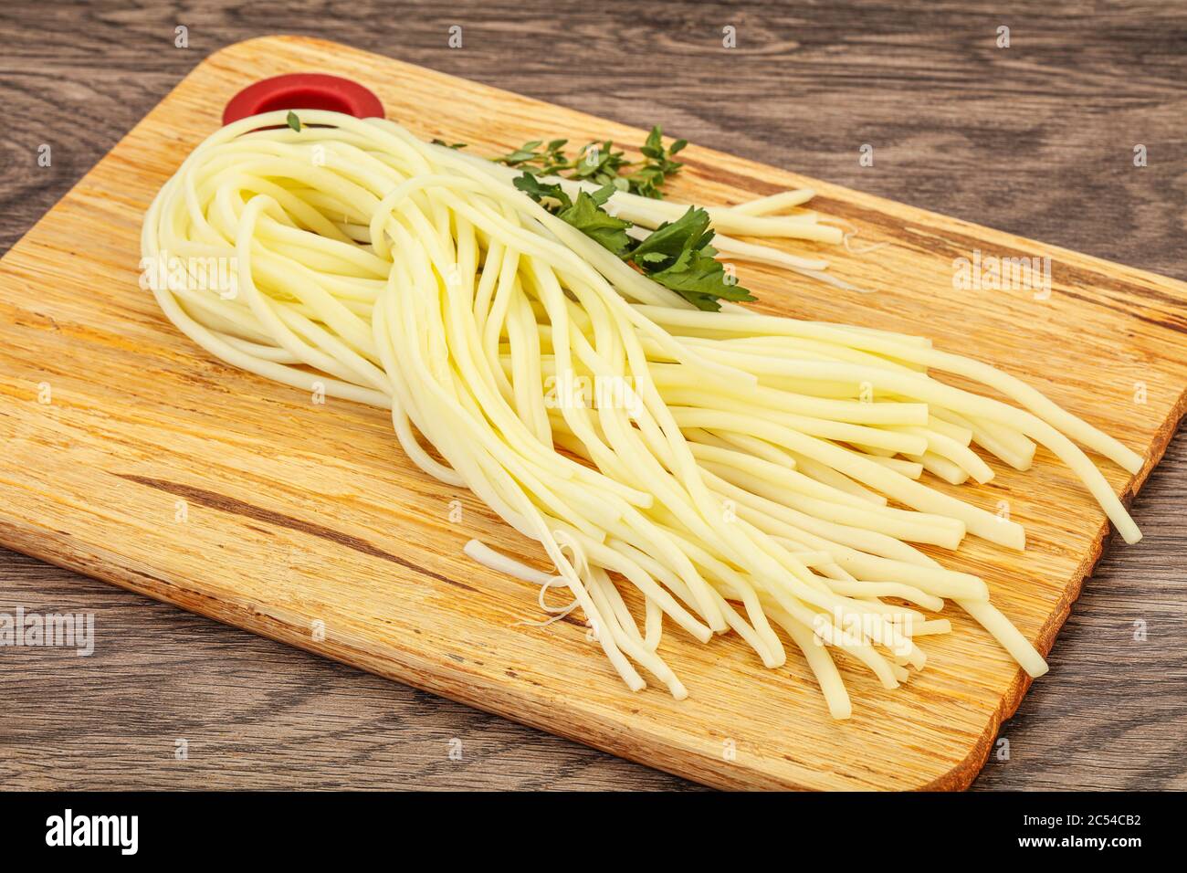Chechil spaghetti cheese snack over board Stock Photo - Alamy