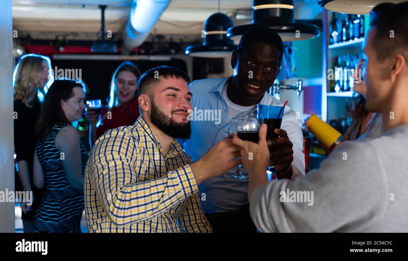 Group of male friends chatting in nightclub Stock Photo - Alamy
