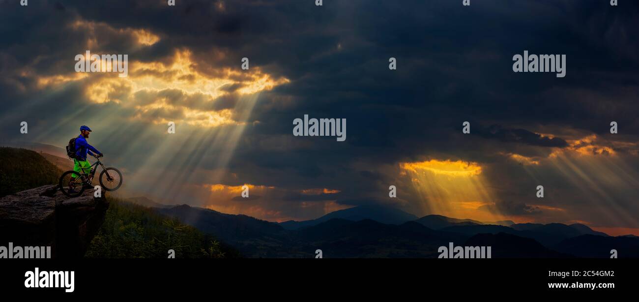 Cycling man riding on bike at sunset mountains forest landscape ...