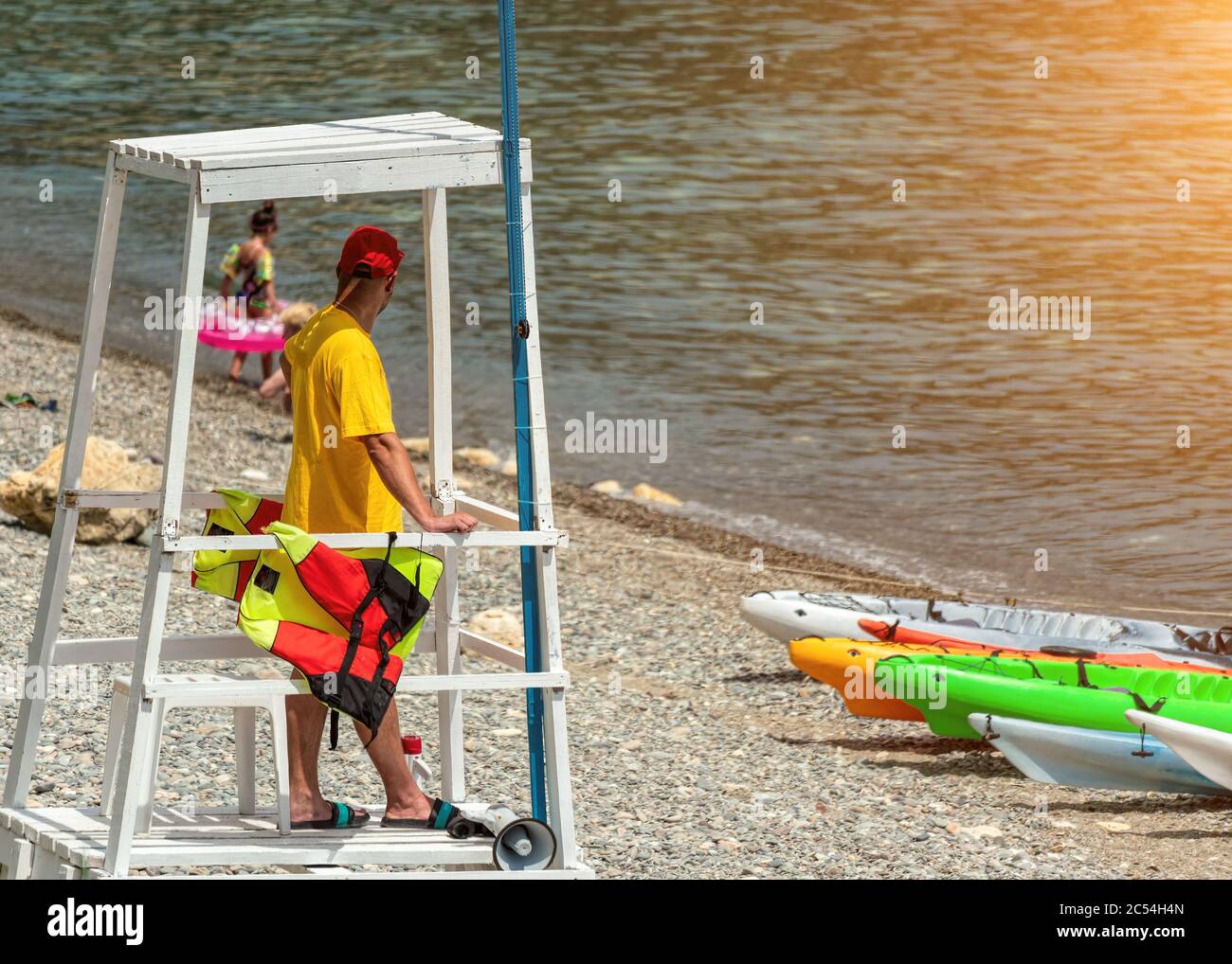 Lifeguard on the tower watches the beach white wood rescue observation ...