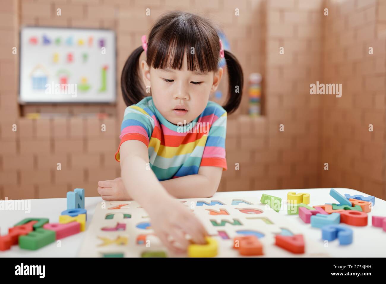 toddler girl learning letter blocks for homeschooling Stock Photo - Alamy