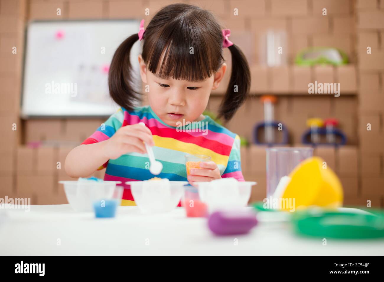 toddler girl play science experiments for homeschooling Stock Photo - Alamy