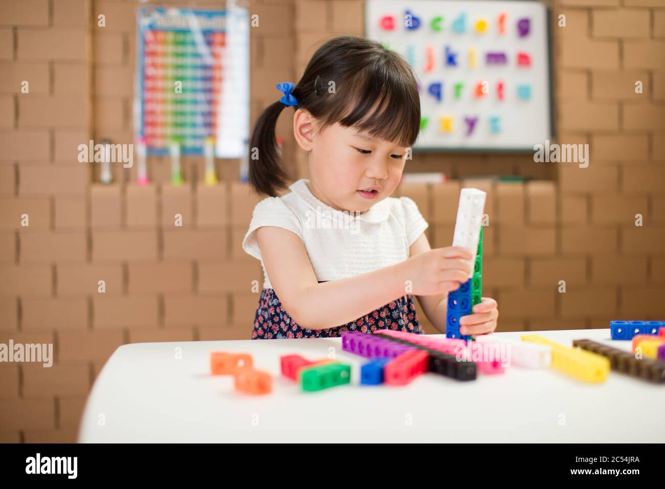 toddler girl play number blocks for homeschooling Stock Photo - Alamy