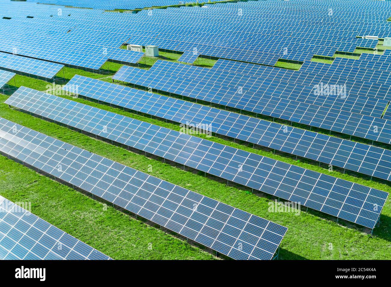 Closeup sun batteries energy in the field with green grass. Solar power ...