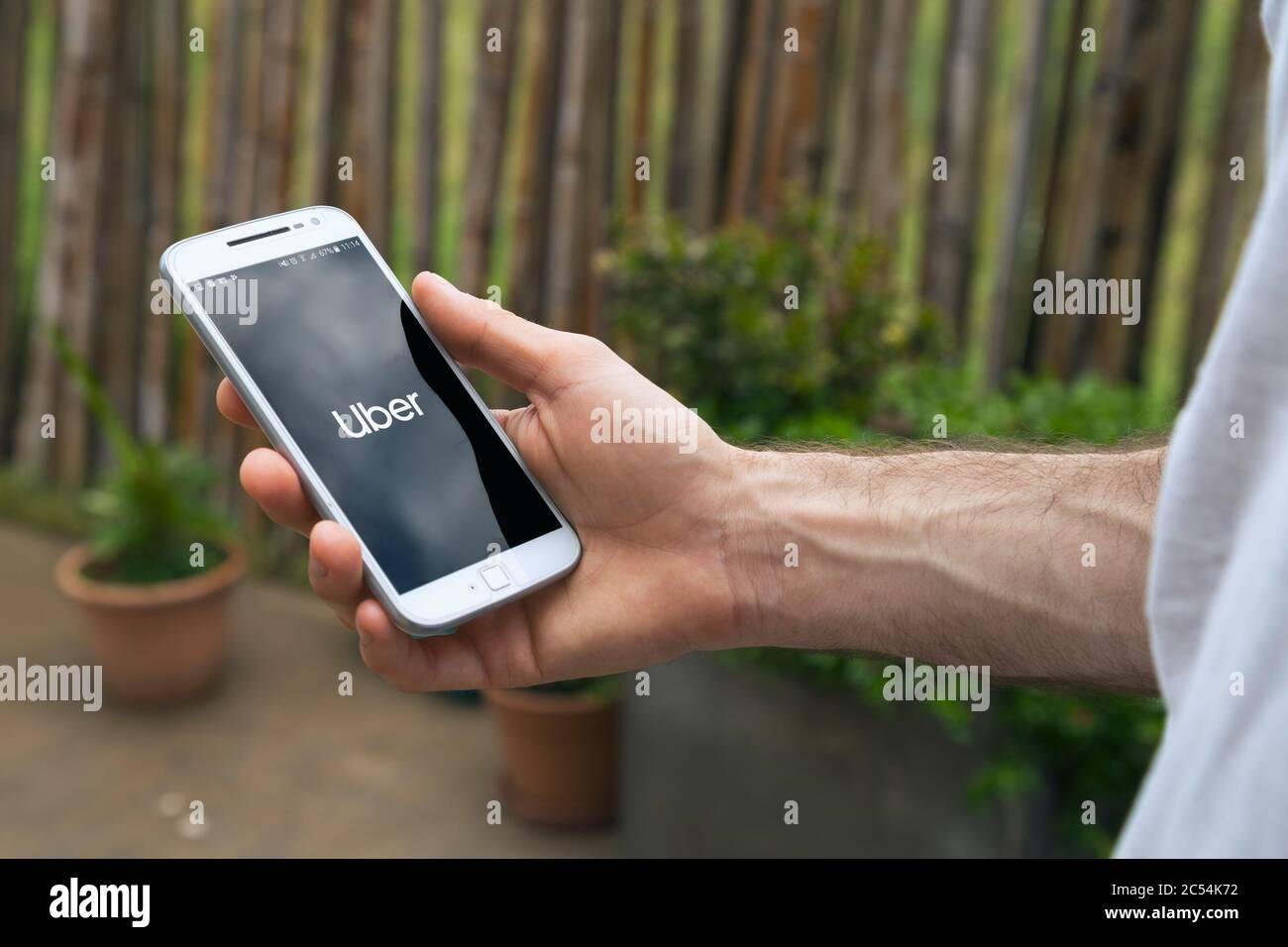 Uber app on screen of a smartphone. App to rent taxi or car ...