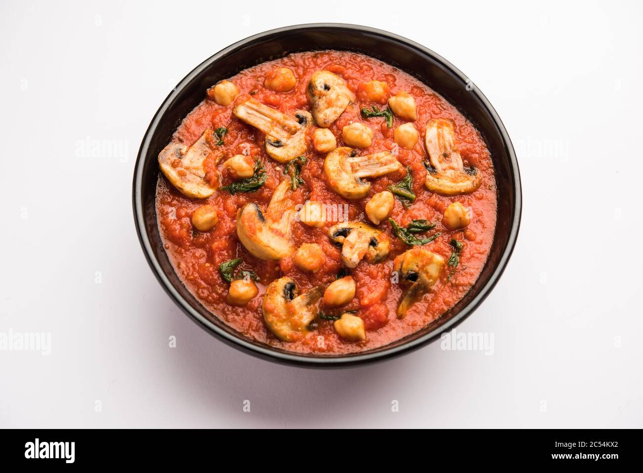 Mushroom sabzi in tomato curry with chickpea and spinach, Indian main ...