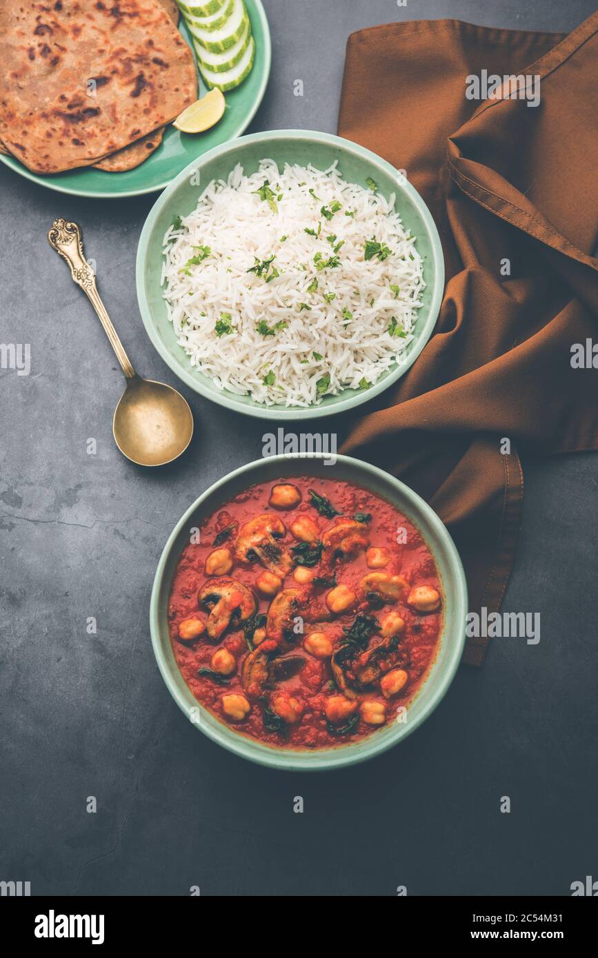 Mushroom sabzi in tomato curry with chickpea and spinach, Indian main ...