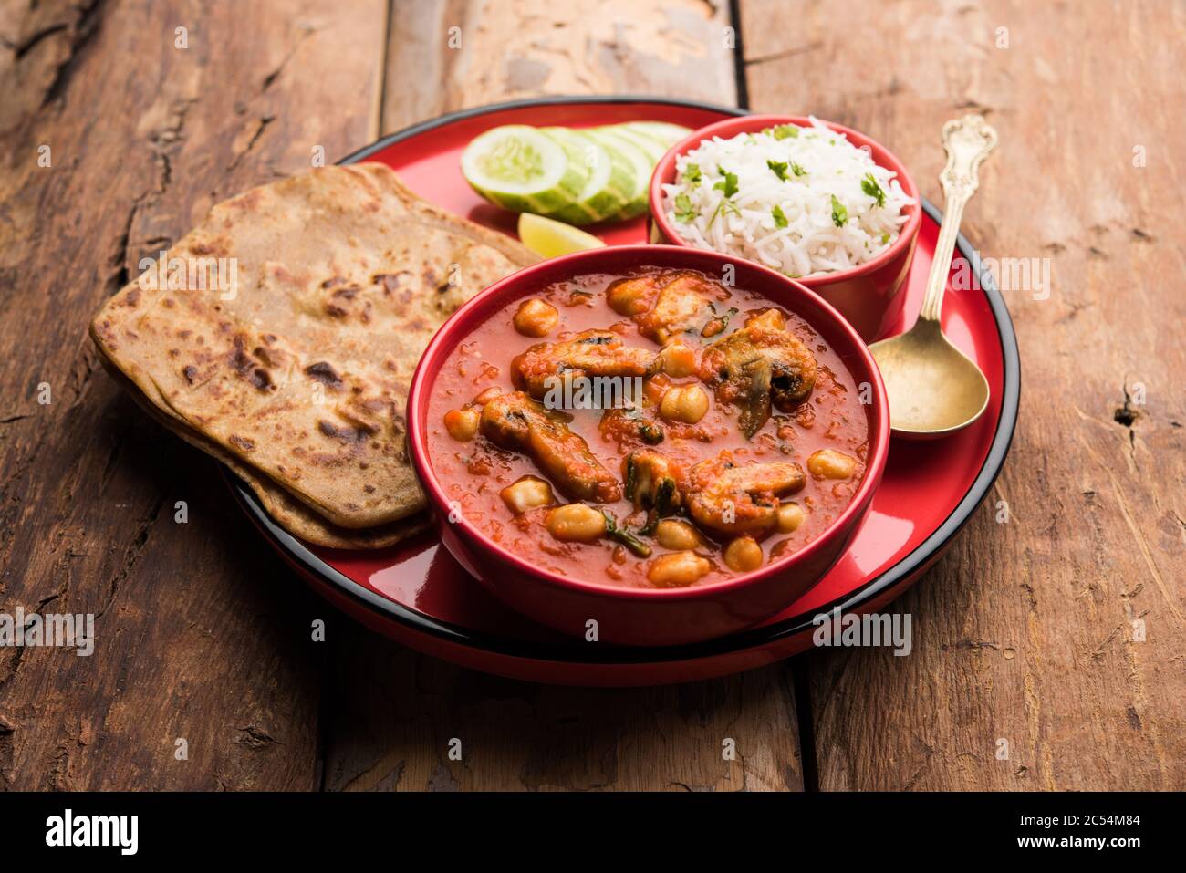 Mushroom sabzi in tomato curry with chickpea and spinach, Indian main ...
