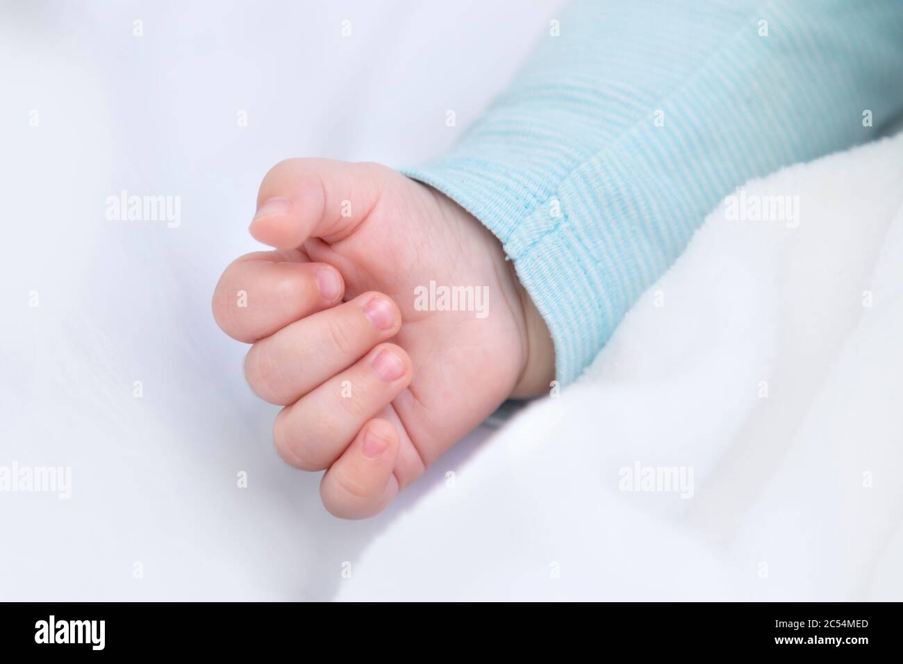 Baby sleeping in a cradle. Hand detail Stock Photo - Alamy
